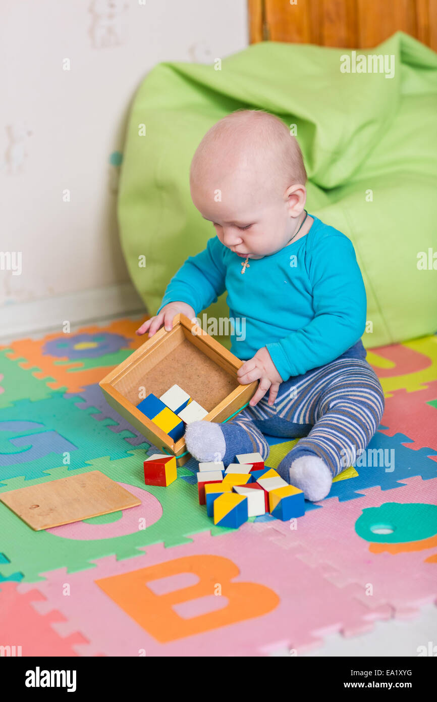 Cute little baby playing with colorful toys at home Stock Photo - Alamy