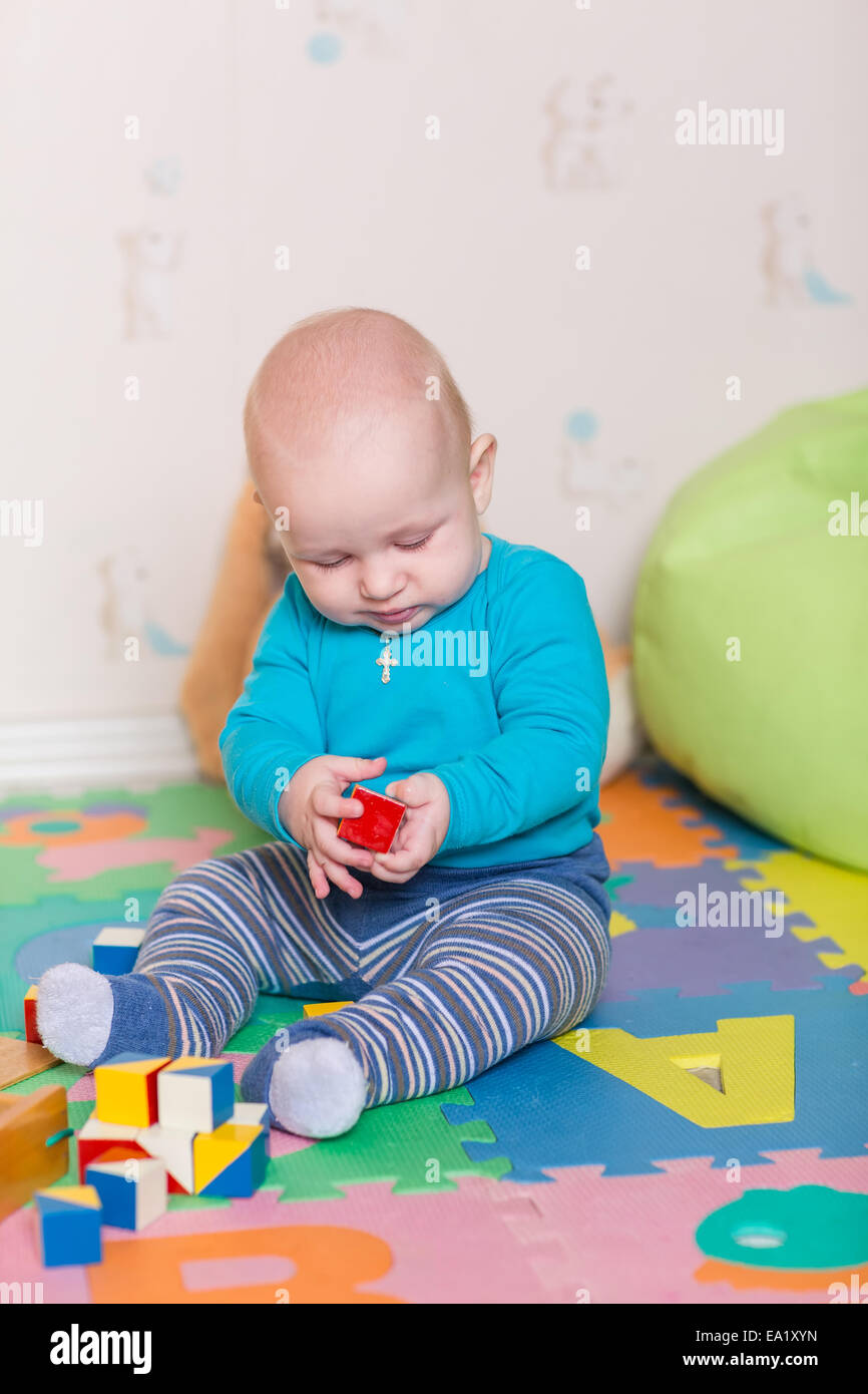 Cute little baby playing with colorful toys at home Stock Photo - Alamy
