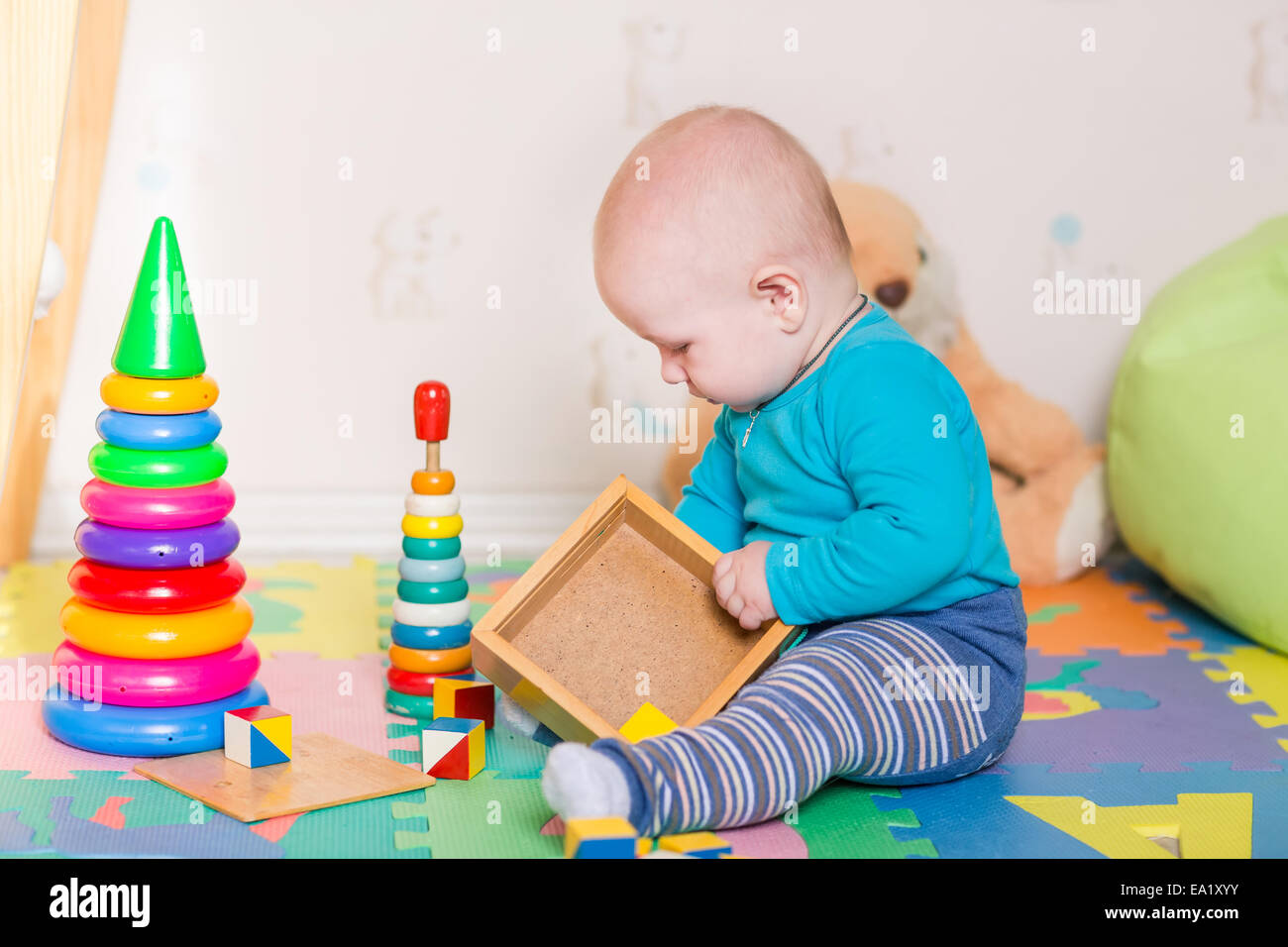 Cute little baby playing with colorful toys at home Stock Photo - Alamy