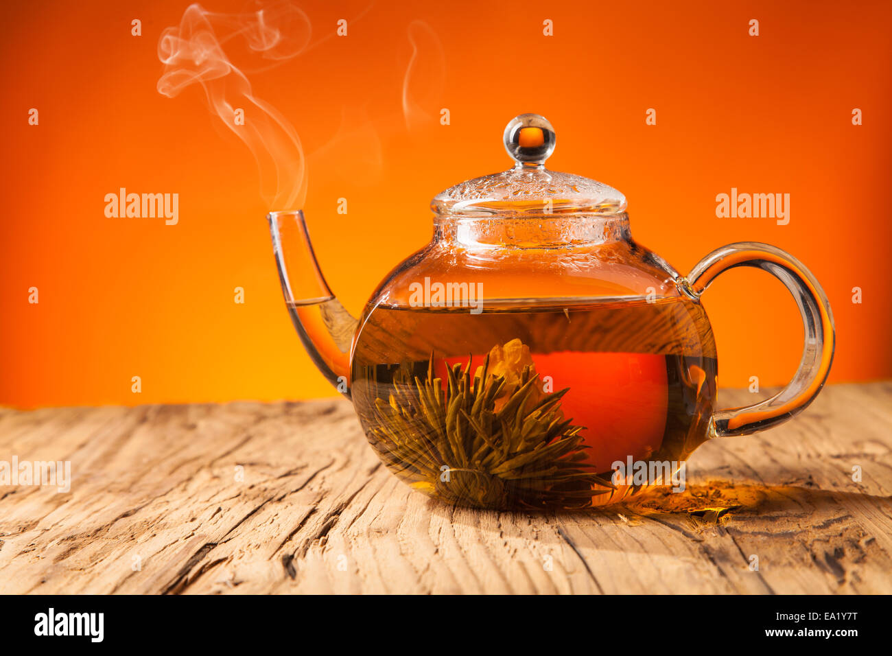 Teapot with blooming tea on wooden planks Stock Photo - Alamy