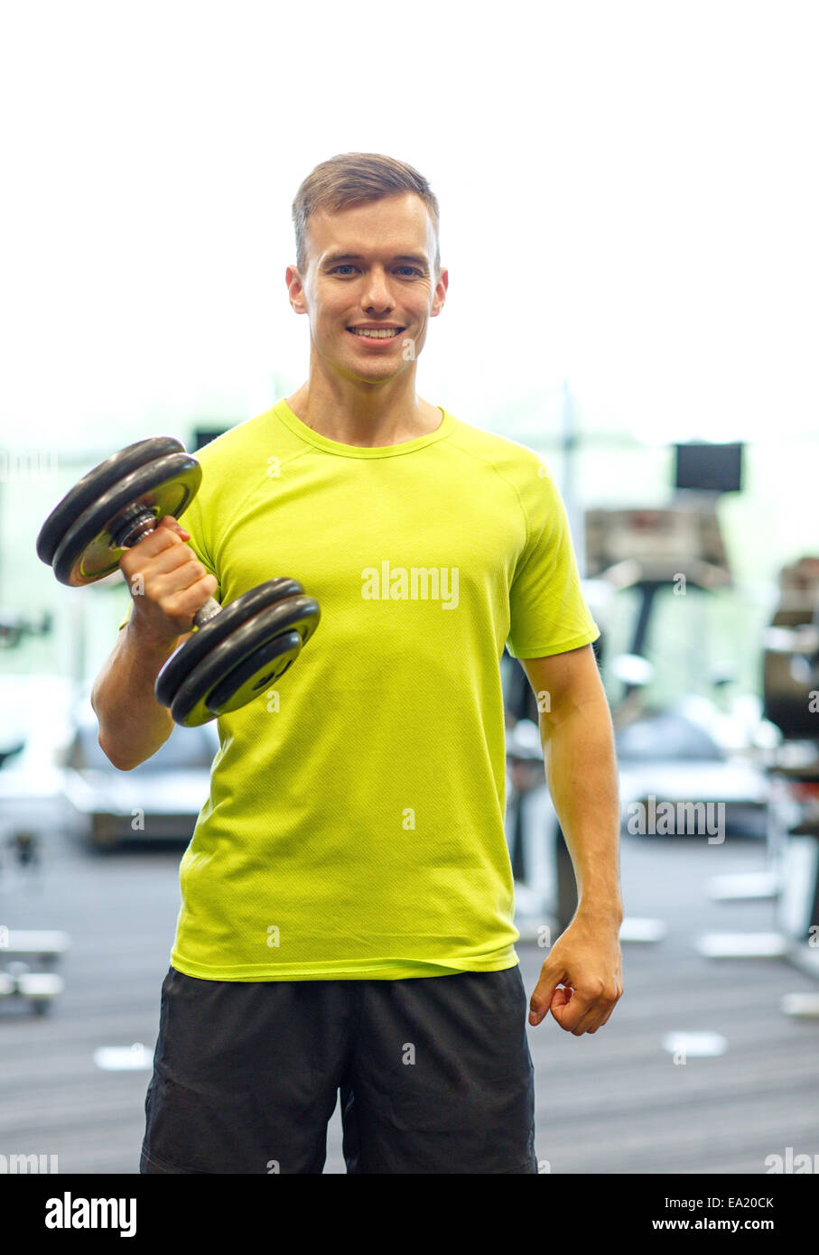 smiling man with dumbbell in gym Stock Photo - Alamy