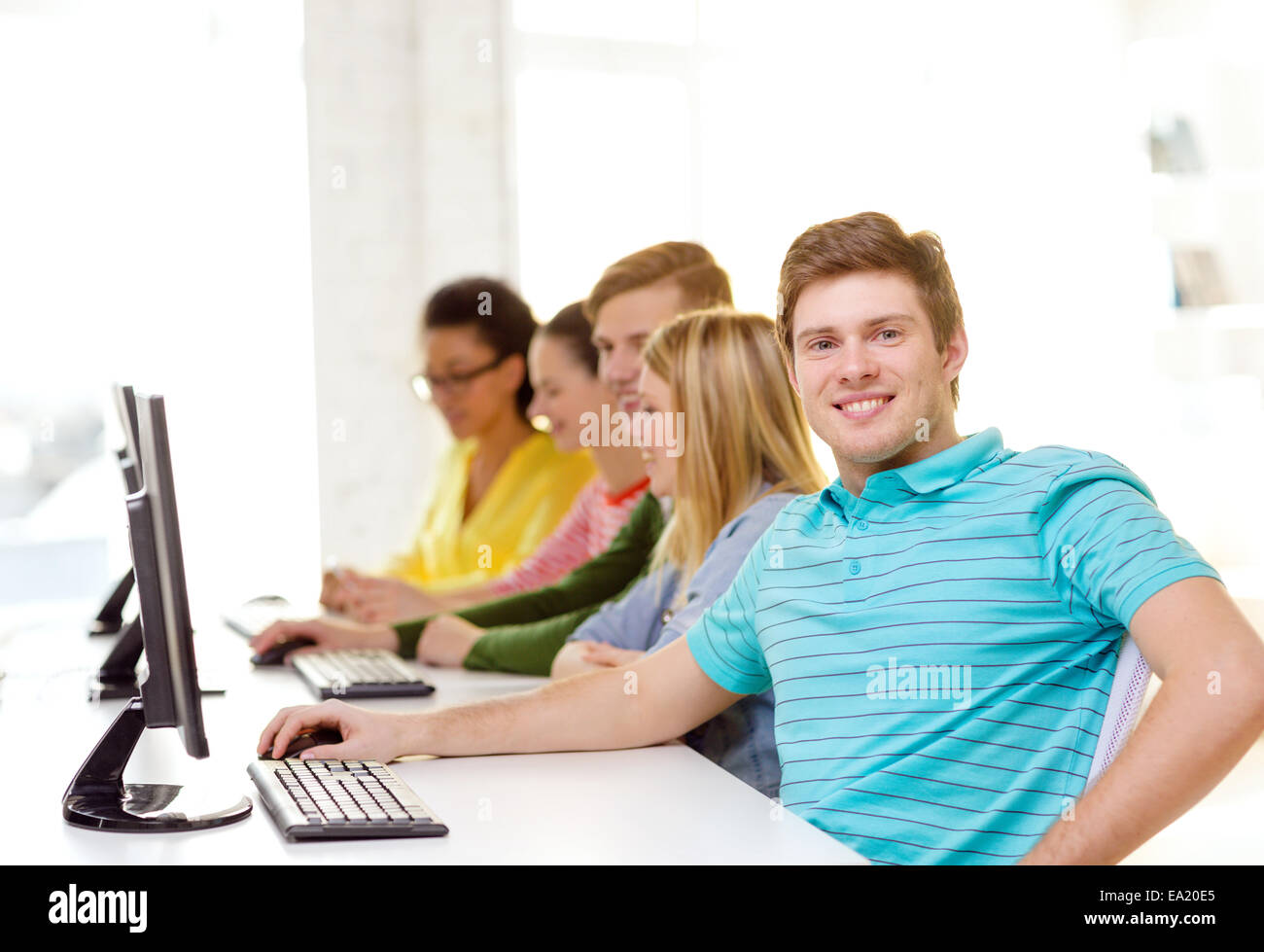male student with classmates in computer class Stock Photo - Alamy