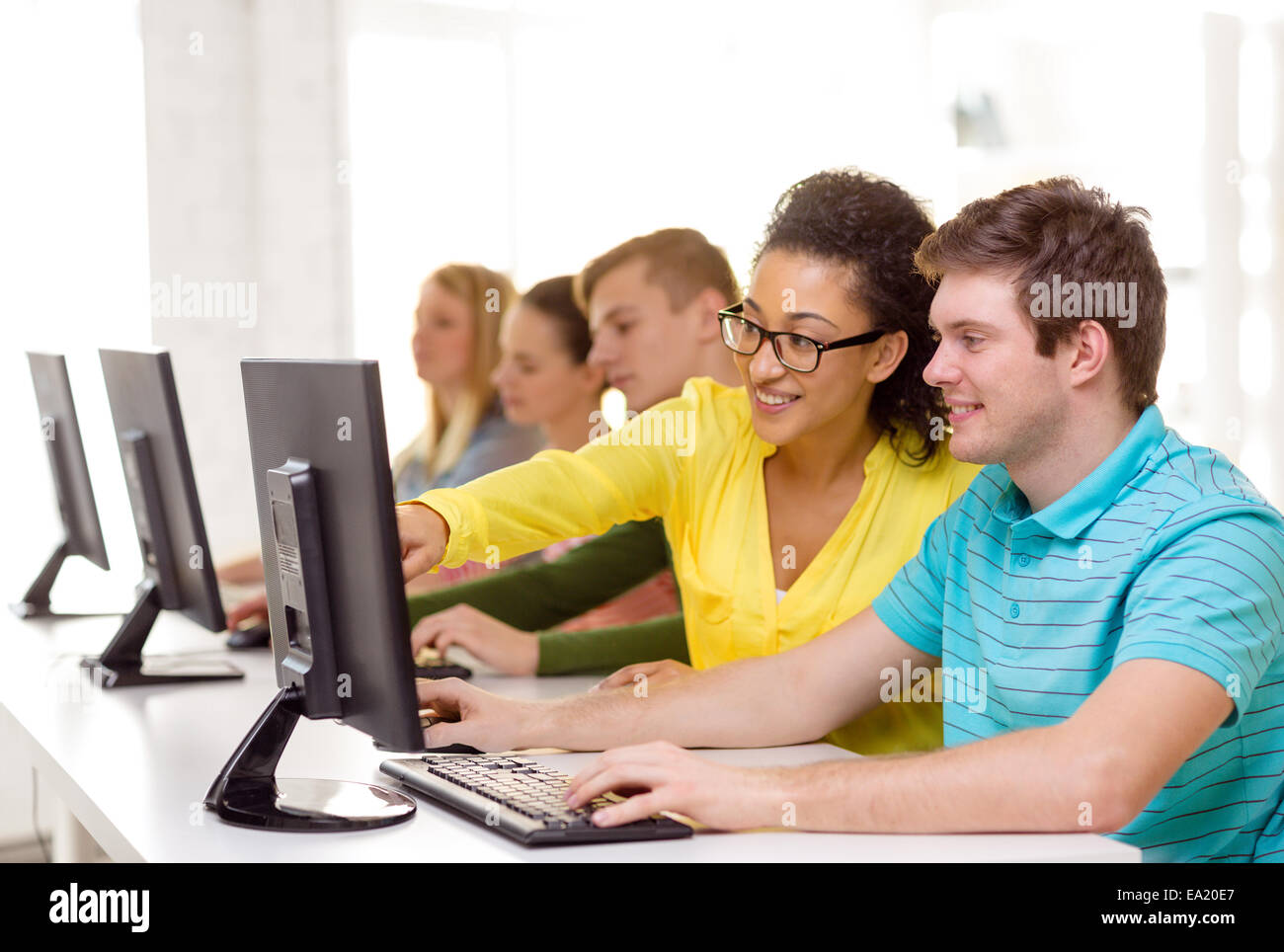smiling students in computer class at school Stock Photo - Alamy