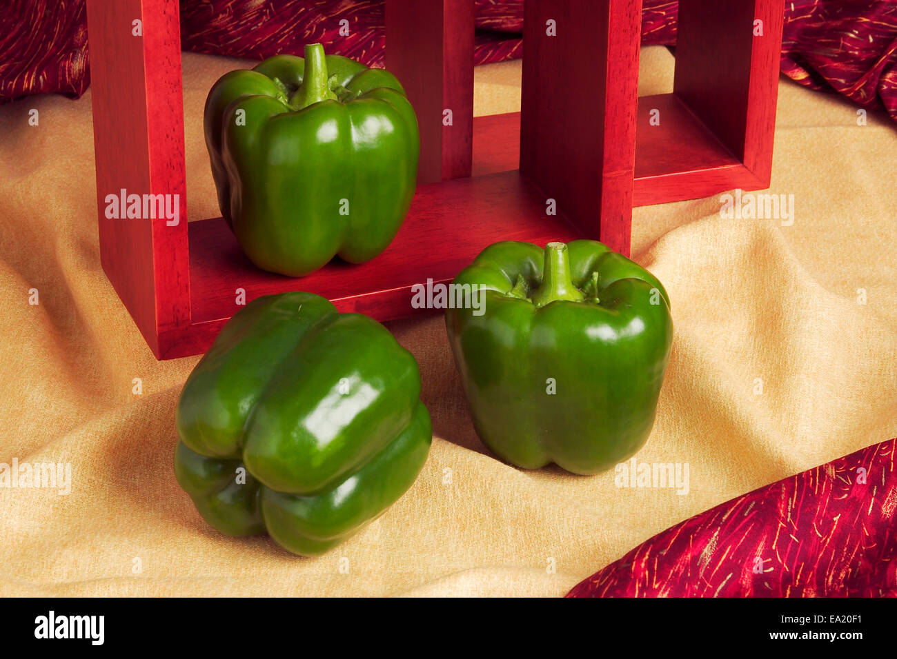 Agriculture - Three green bell peppers in a studio setting with red ...