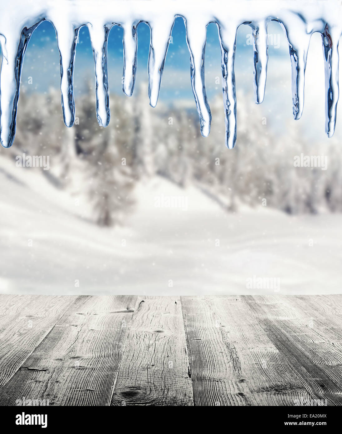 Snowy winter landscape with empty wooden planks and icicles Stock Photo ...