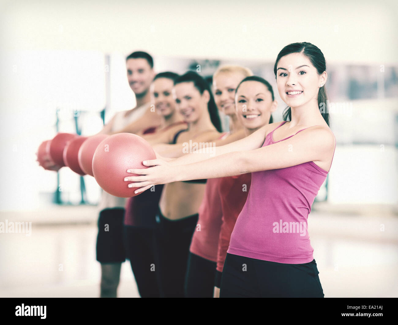 group of smiling people working out with ball Stock Photo - Alamy