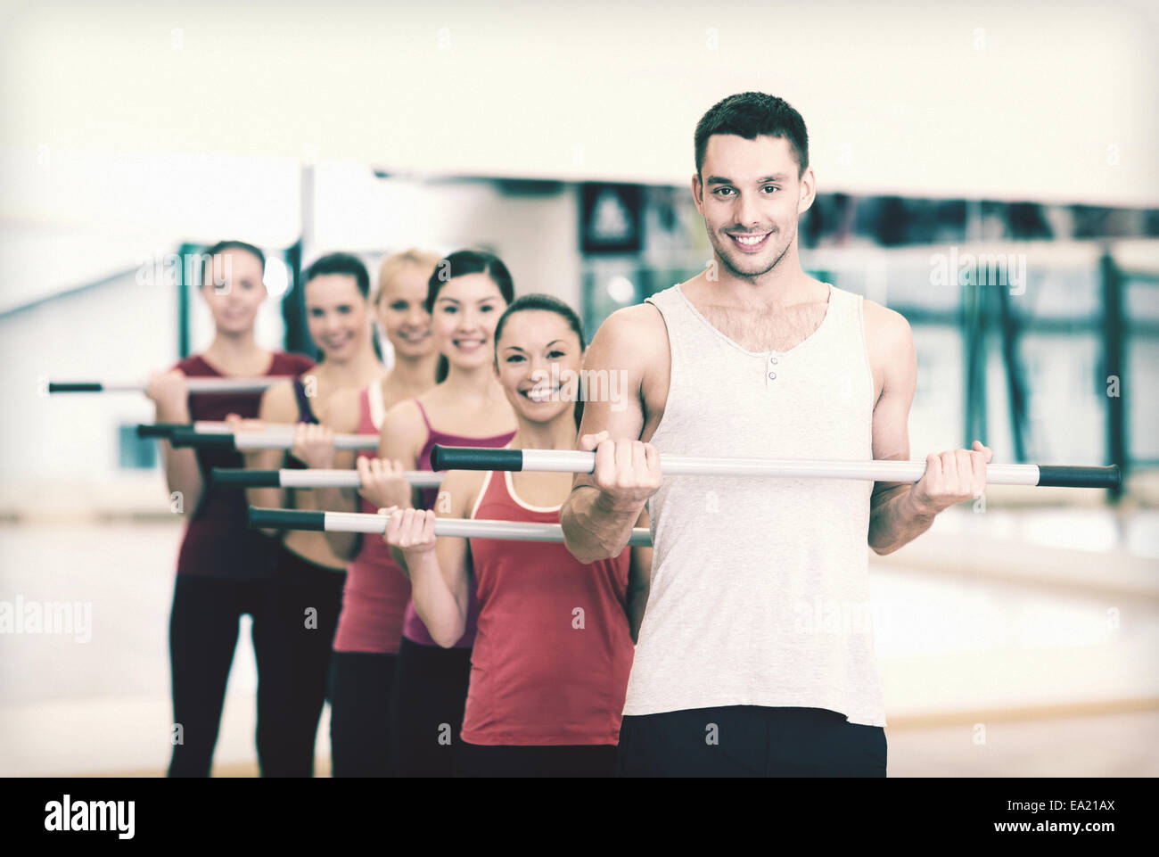 group of smiling people working out with barbells Stock Photo - Alamy