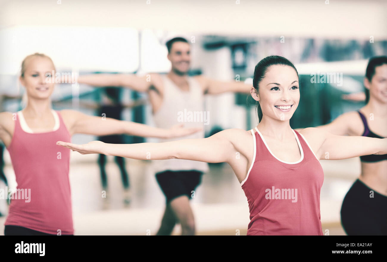 group of smiling people exercising in the gym Stock Photo - Alamy