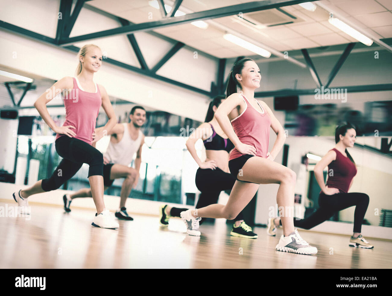 group of smiling people exercising in the gym Stock Photo - Alamy