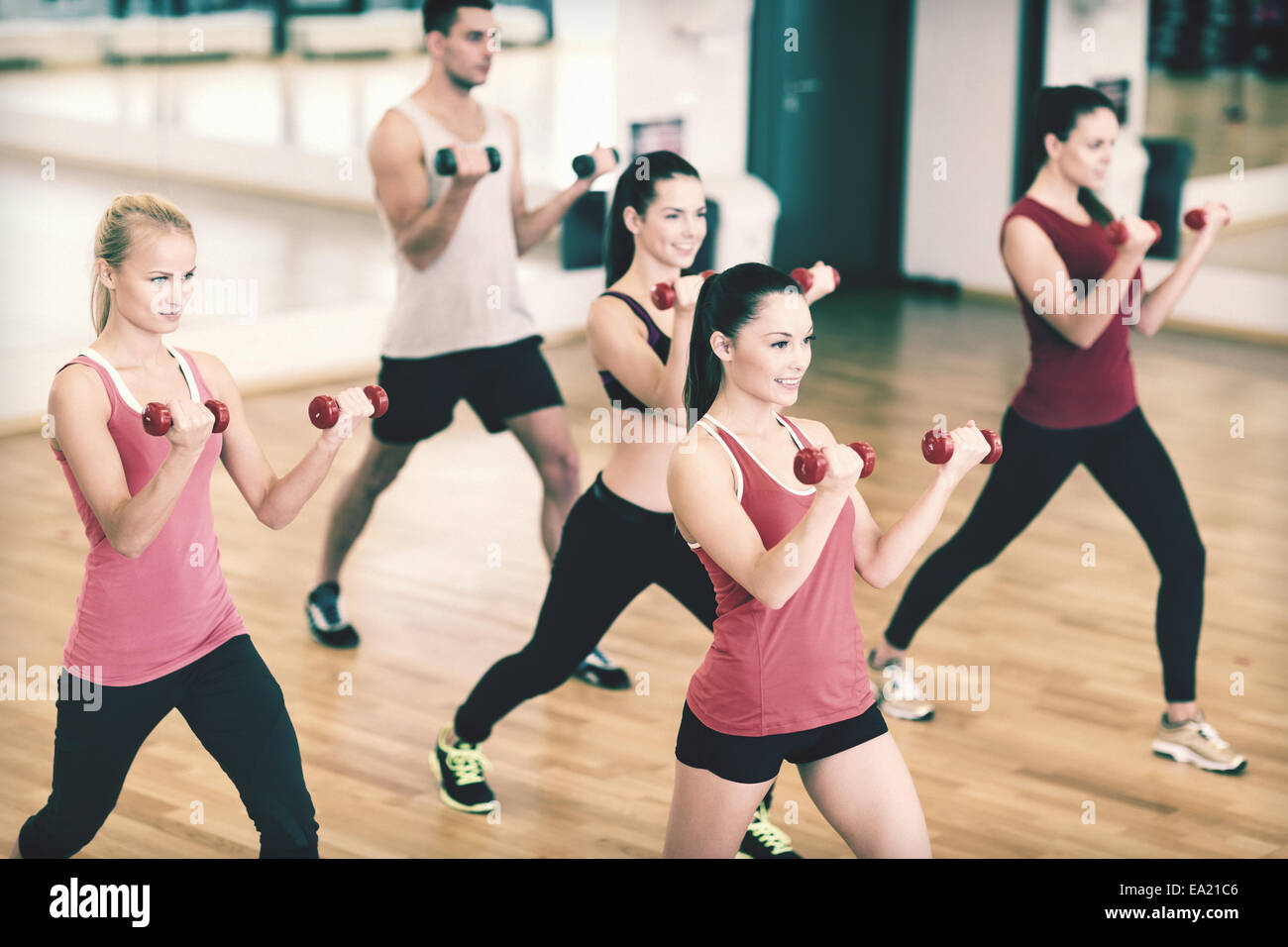 group of smiling people working out with dumbbells Stock Photo - Alamy