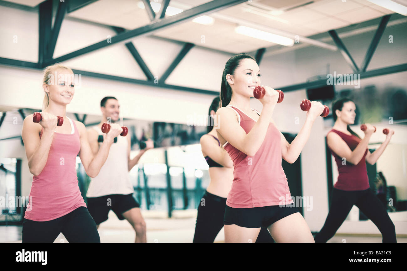 group of smiling people working out with dumbbells Stock Photo - Alamy