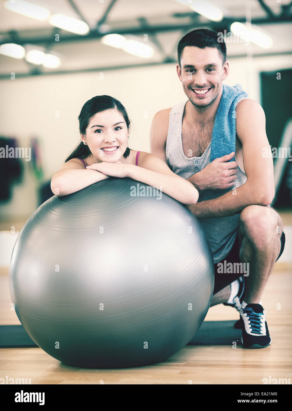 two smiling people with fitness ball Stock Photo - Alamy