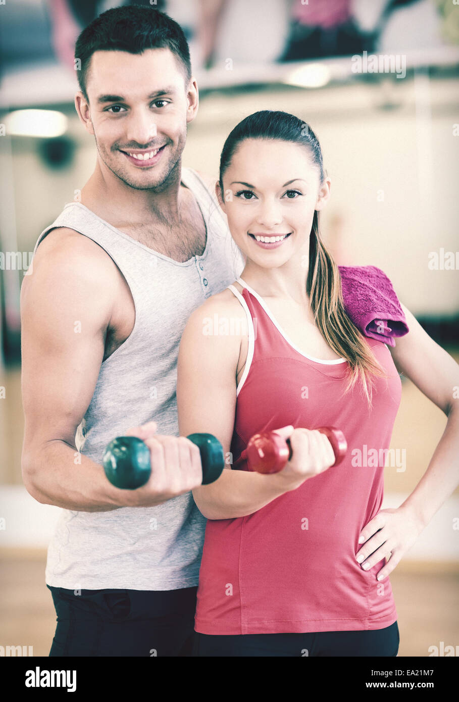 two smiling people working out with dumbbells Stock Photo - Alamy