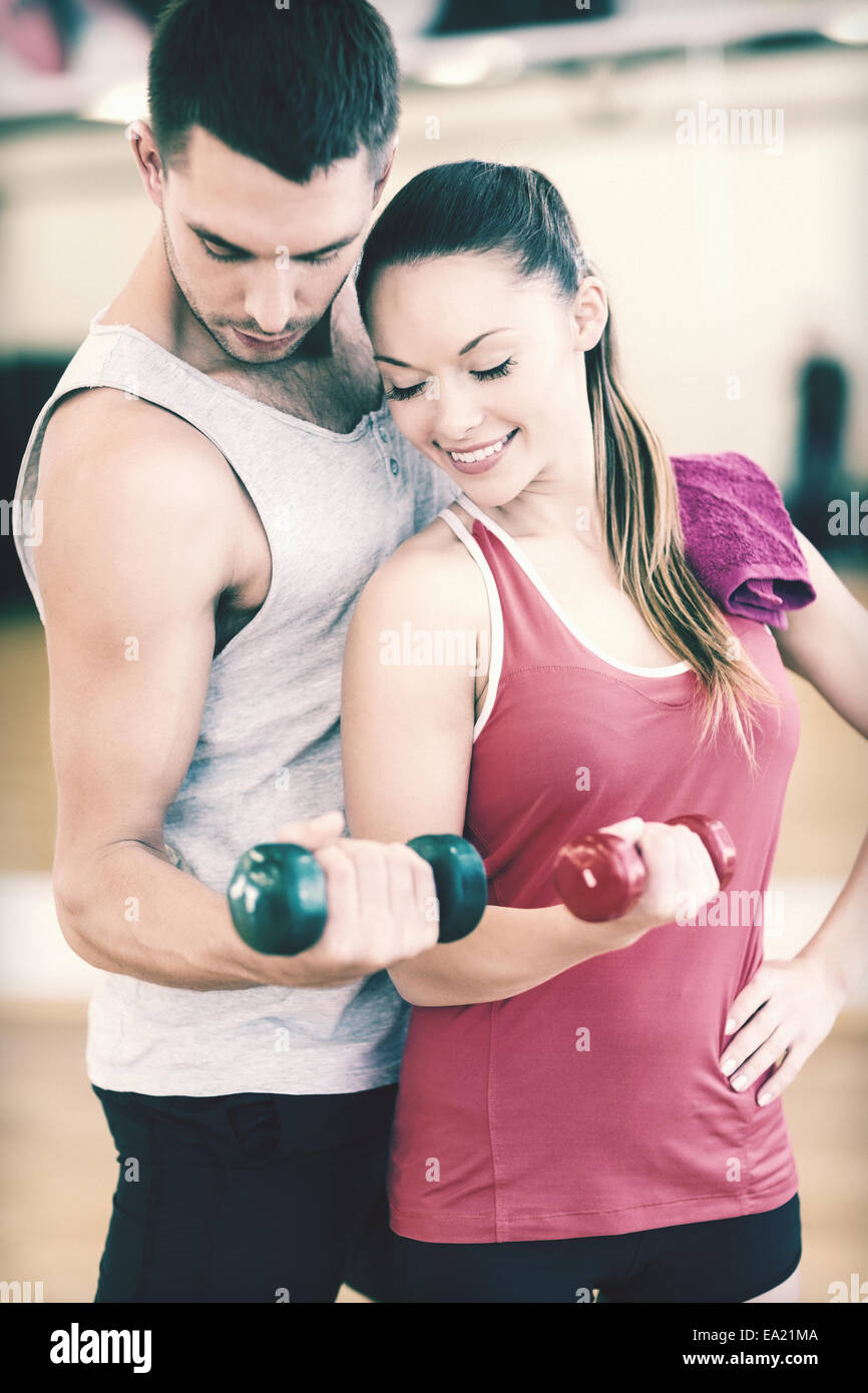 two smiling people working out with dumbbells Stock Photo - Alamy