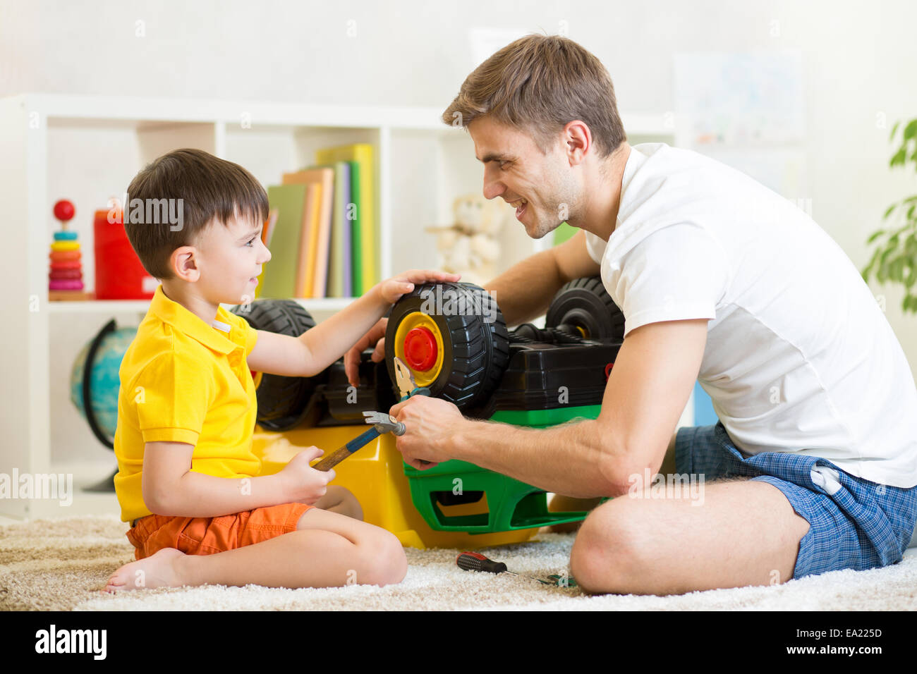 kid boy and his dad repair toy trunk Stock Photo - Alamy