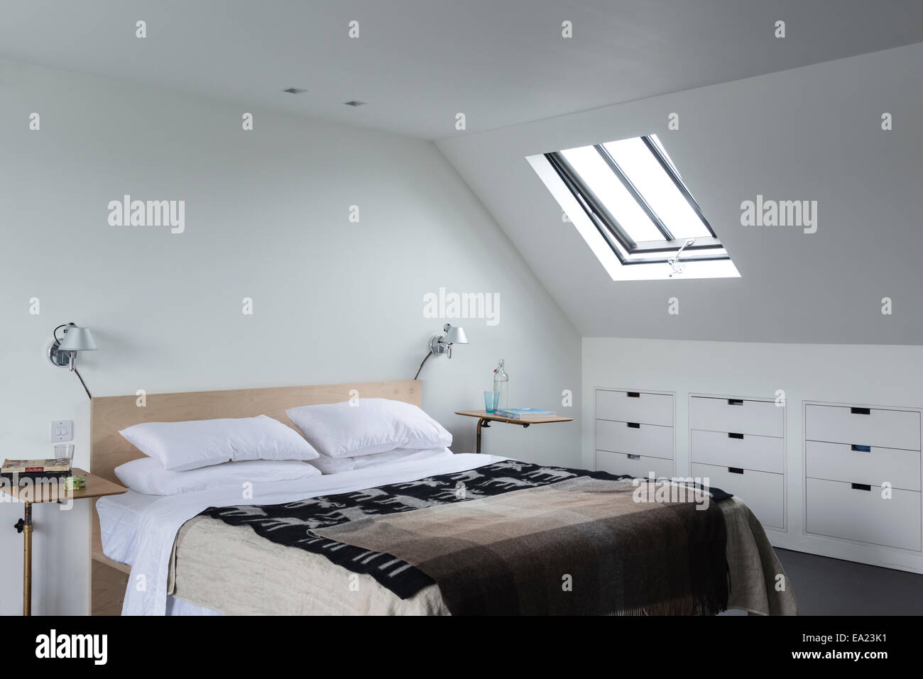 Modern bedroom with skylight and inbuilt drawers Stock Photo - Alamy