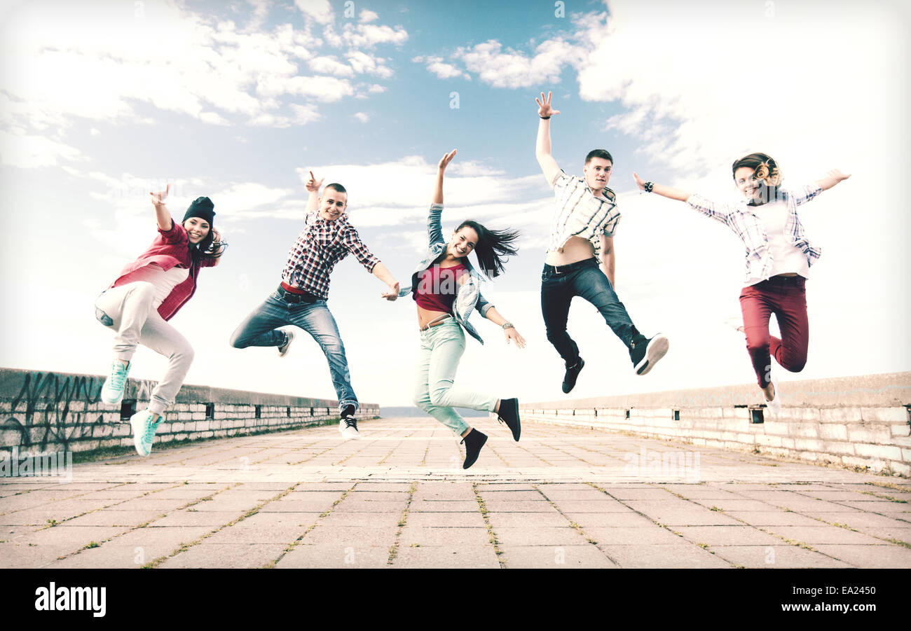 group of teenagers jumping Stock Photo - Alamy