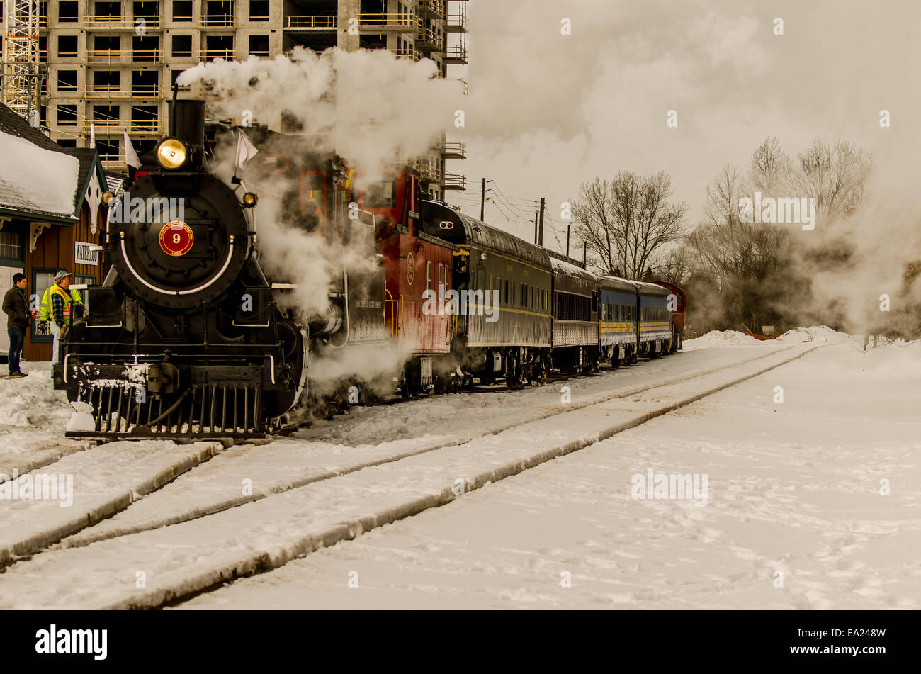 Steam Engine Train is beginning its journey on the snowy track ...