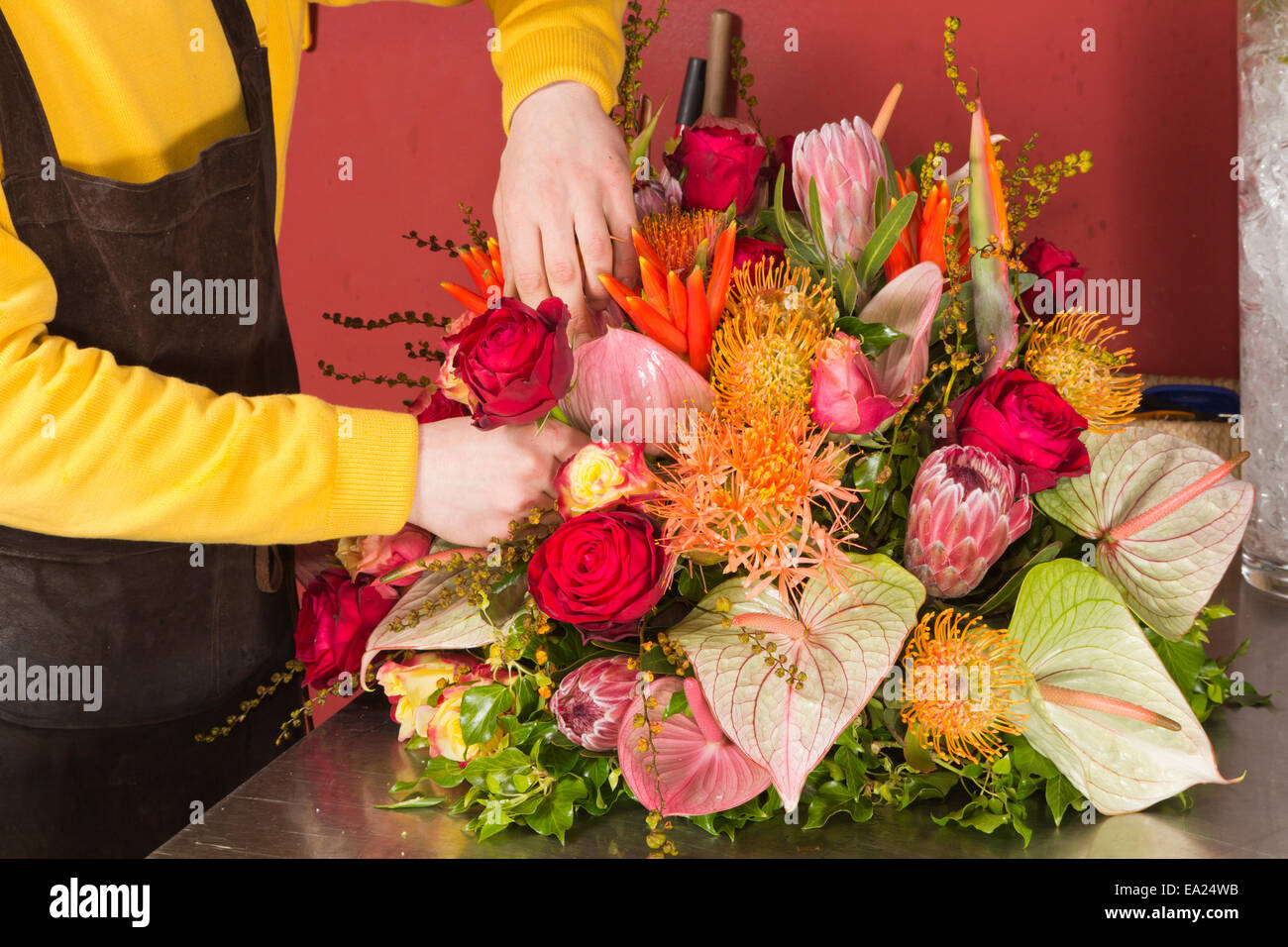 Award winning florist arranging rich flower arrangement Stock Photo - Alamy