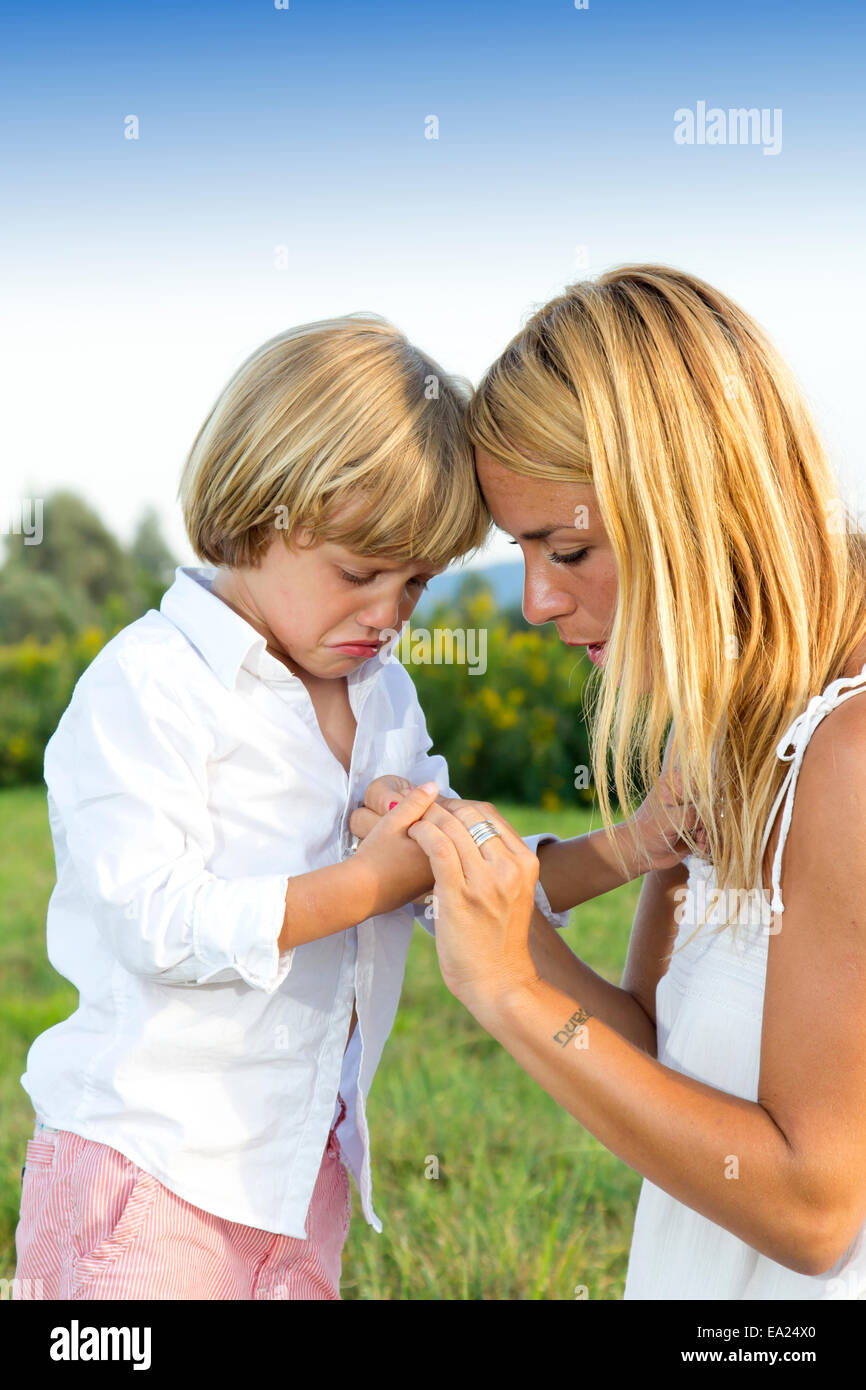 Crying young boy with finger injury Stock Photo - Alamy