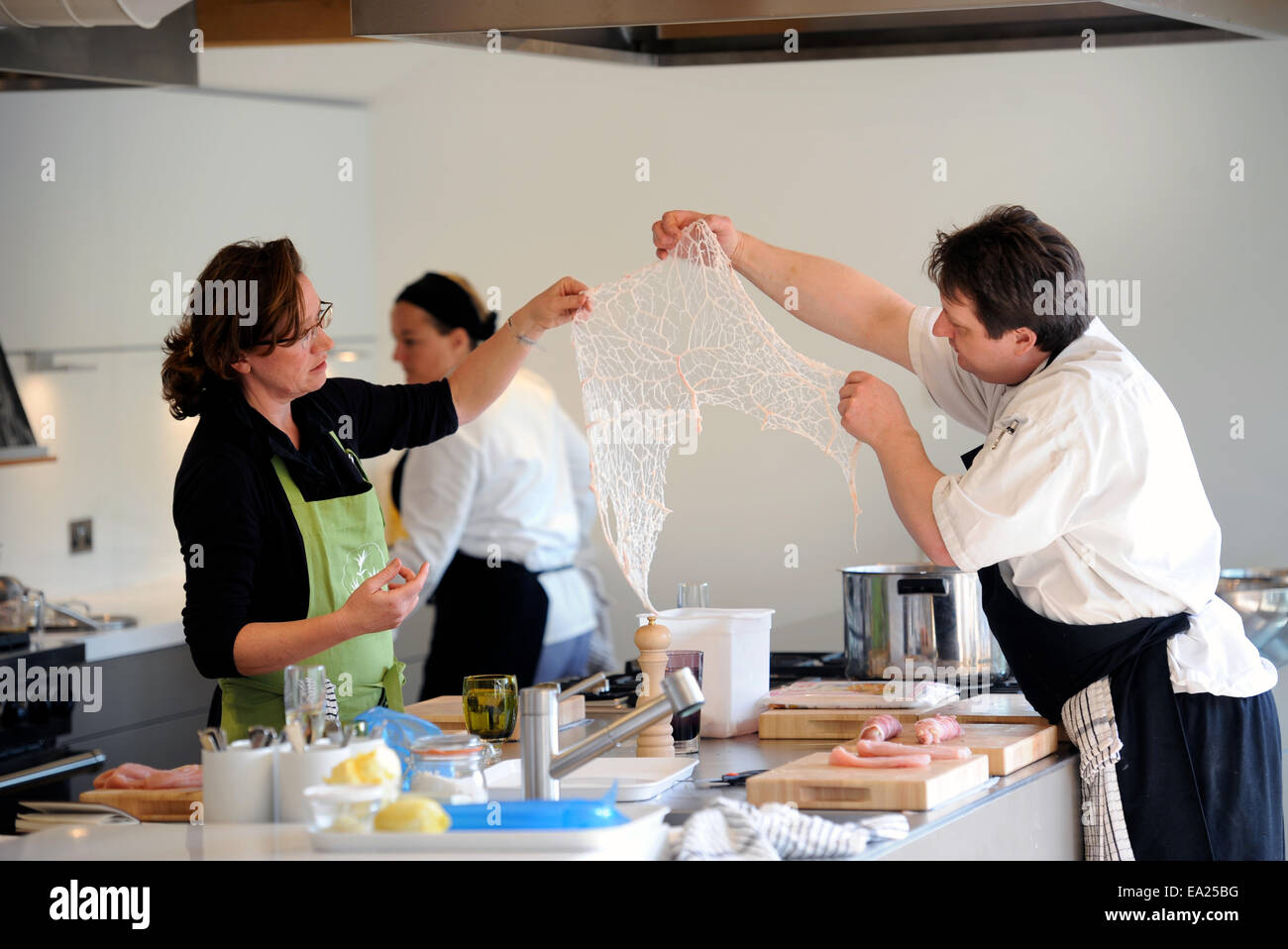 Using caul fat to wrap a chicken dish during a cookery school at Thyme ...
