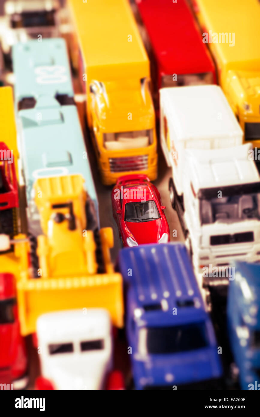 A car is caught in traffic between many trucks Stock Photo - Alamy