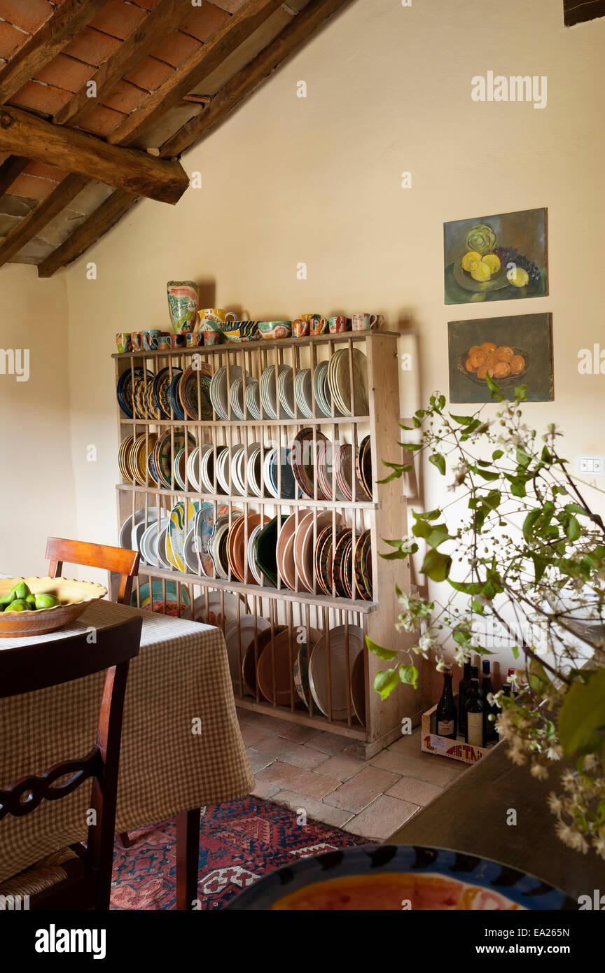 Large standing plate rack filled with brightly coloured plates in ...