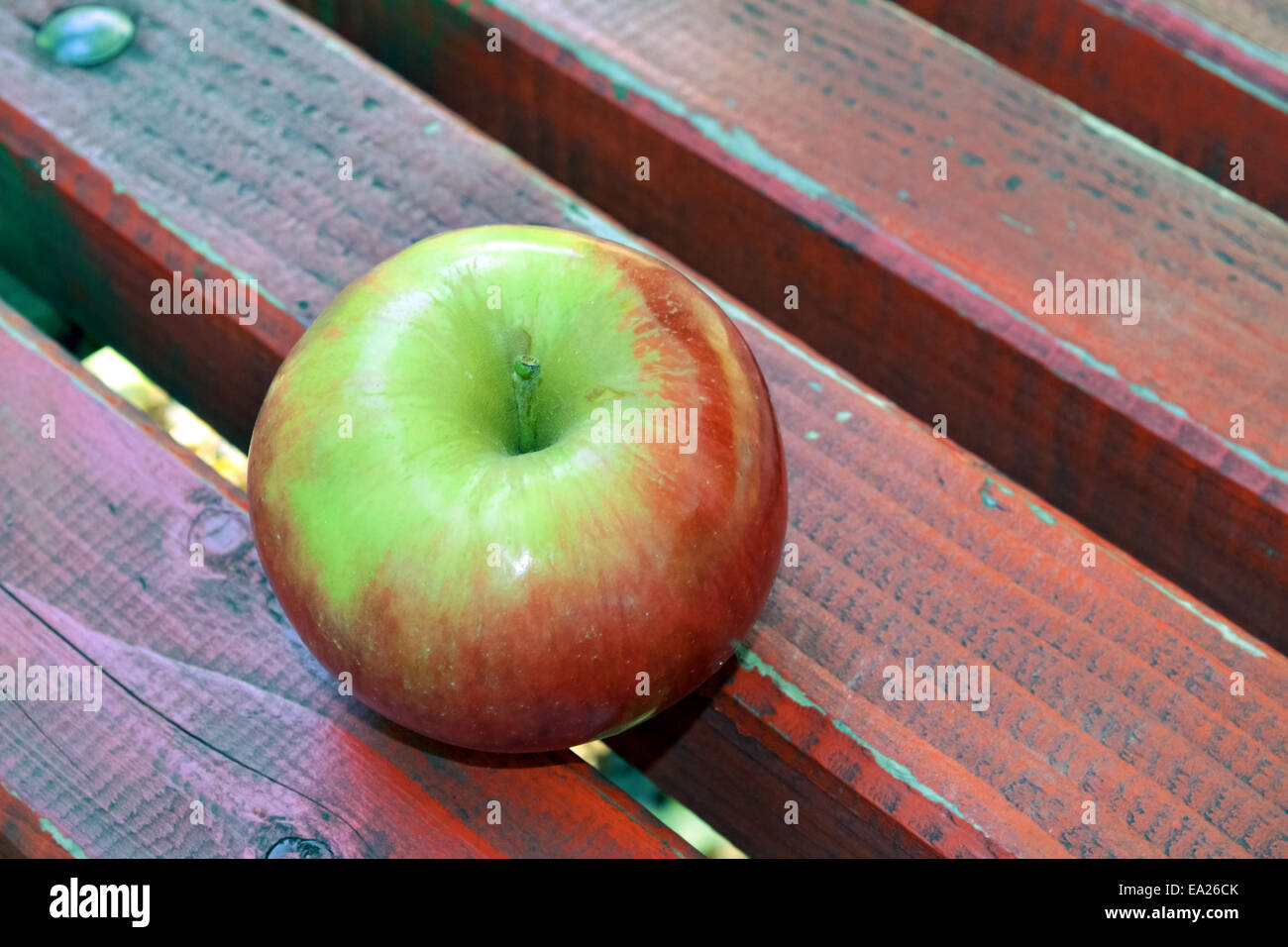 Closeup of an apple on a park bench in pastel colors Stock Photo - Alamy