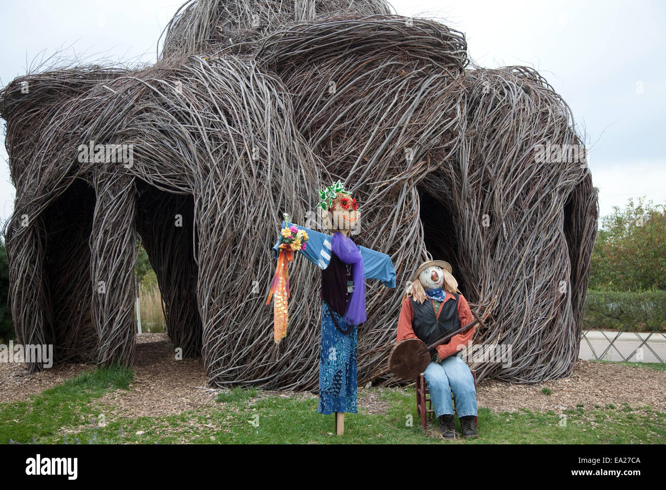 Halloween costumed figures outside their fanciful straw hut. Minnesota ...