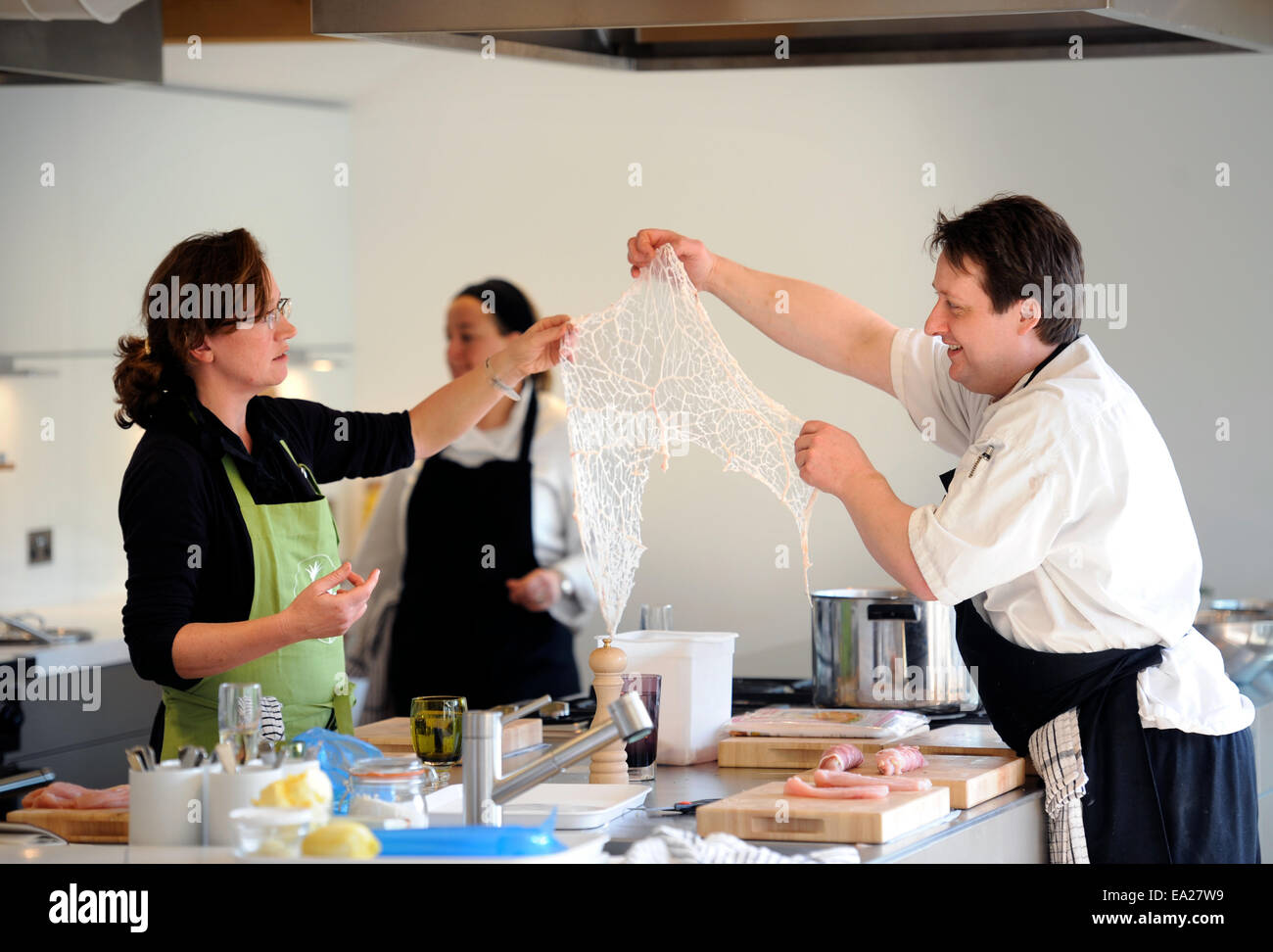 Using caul fat to wrap a chicken dish during a cookery school at Thyme ...