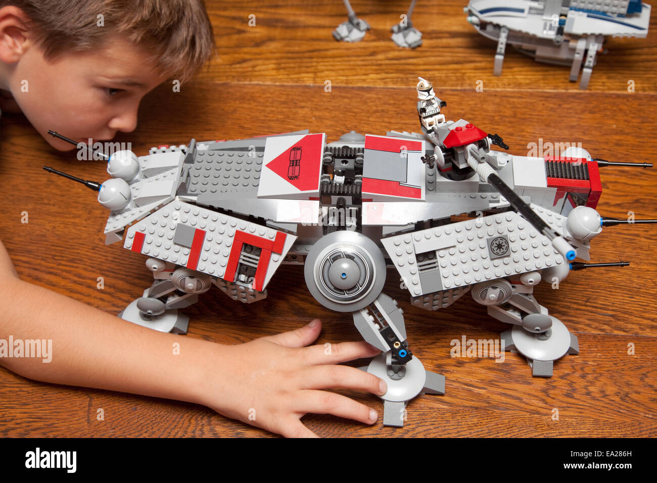 Boy age 8 playing with his Lego war fighting machine. St Paul Minnesota ...