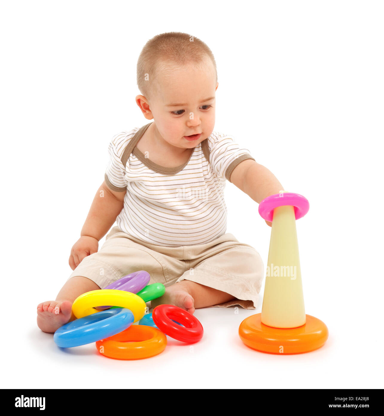 Little boy sitting and playing with colorful plastic torus toy Stock ...