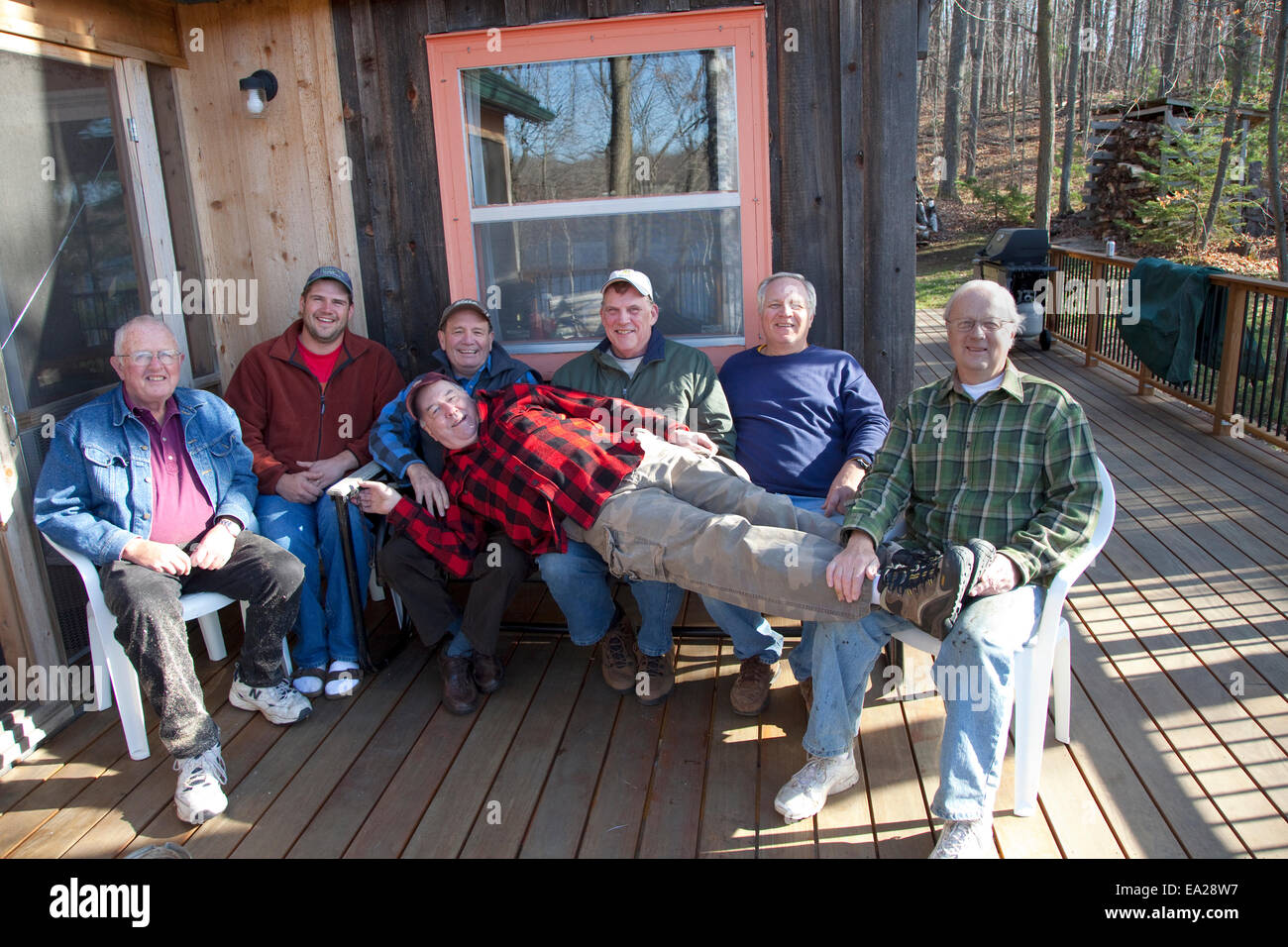 Men's weekend woodchopping encounter group enjoying a moment before ...