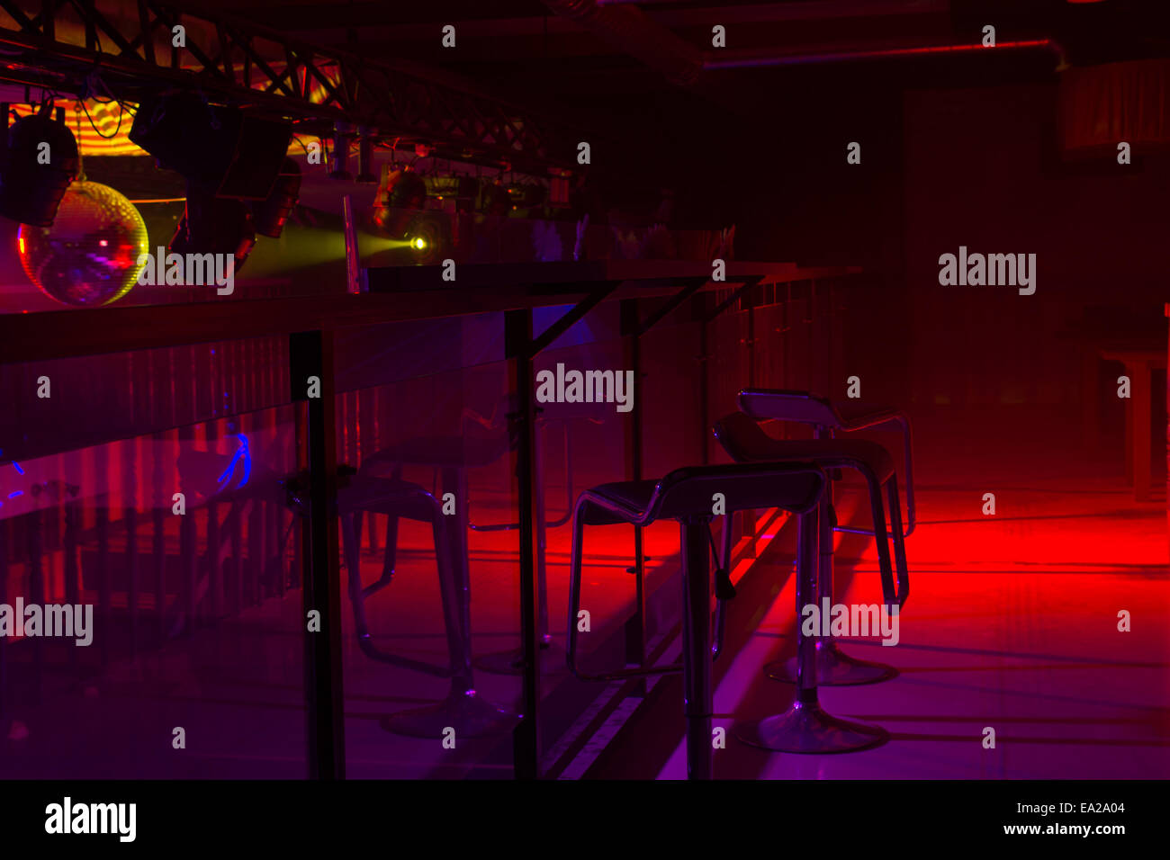 Modern bar interior decor and colorful red and purple strobe lighting ...