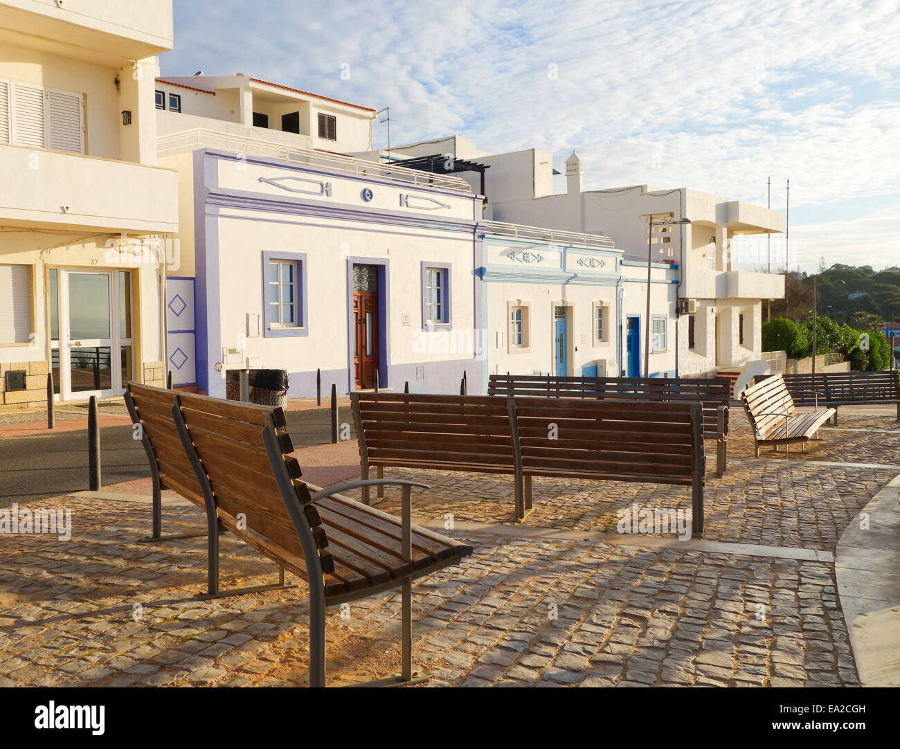 Typical Portuguese Town houses in Albufeira with benches in front ...