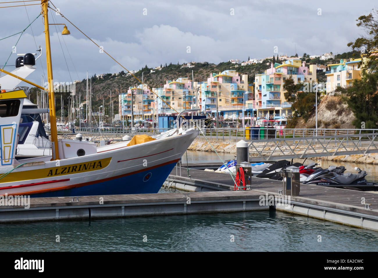 Boat in port, Colourful buildings in Albufeira marina, Algarve ...