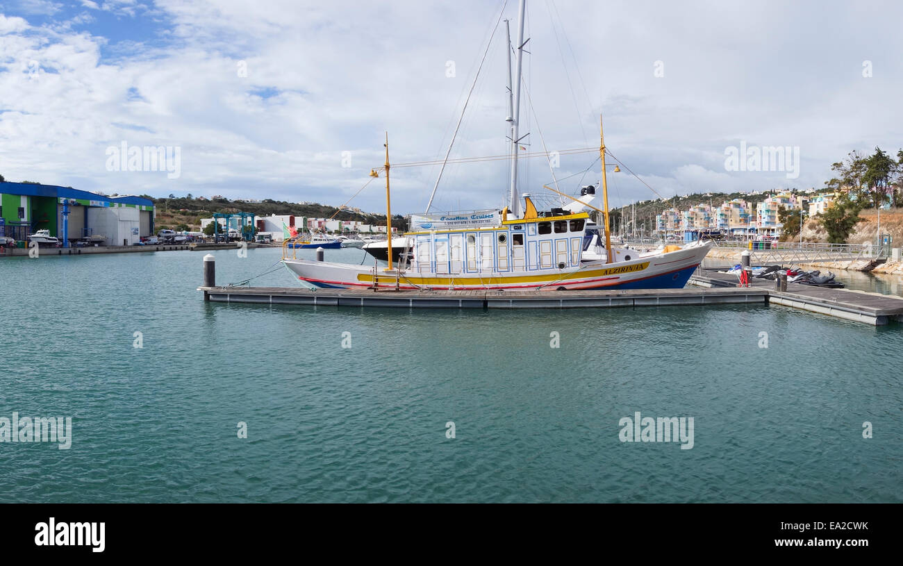 Boat in port, Colourful buildings in Albufeira marina, Algarve ...