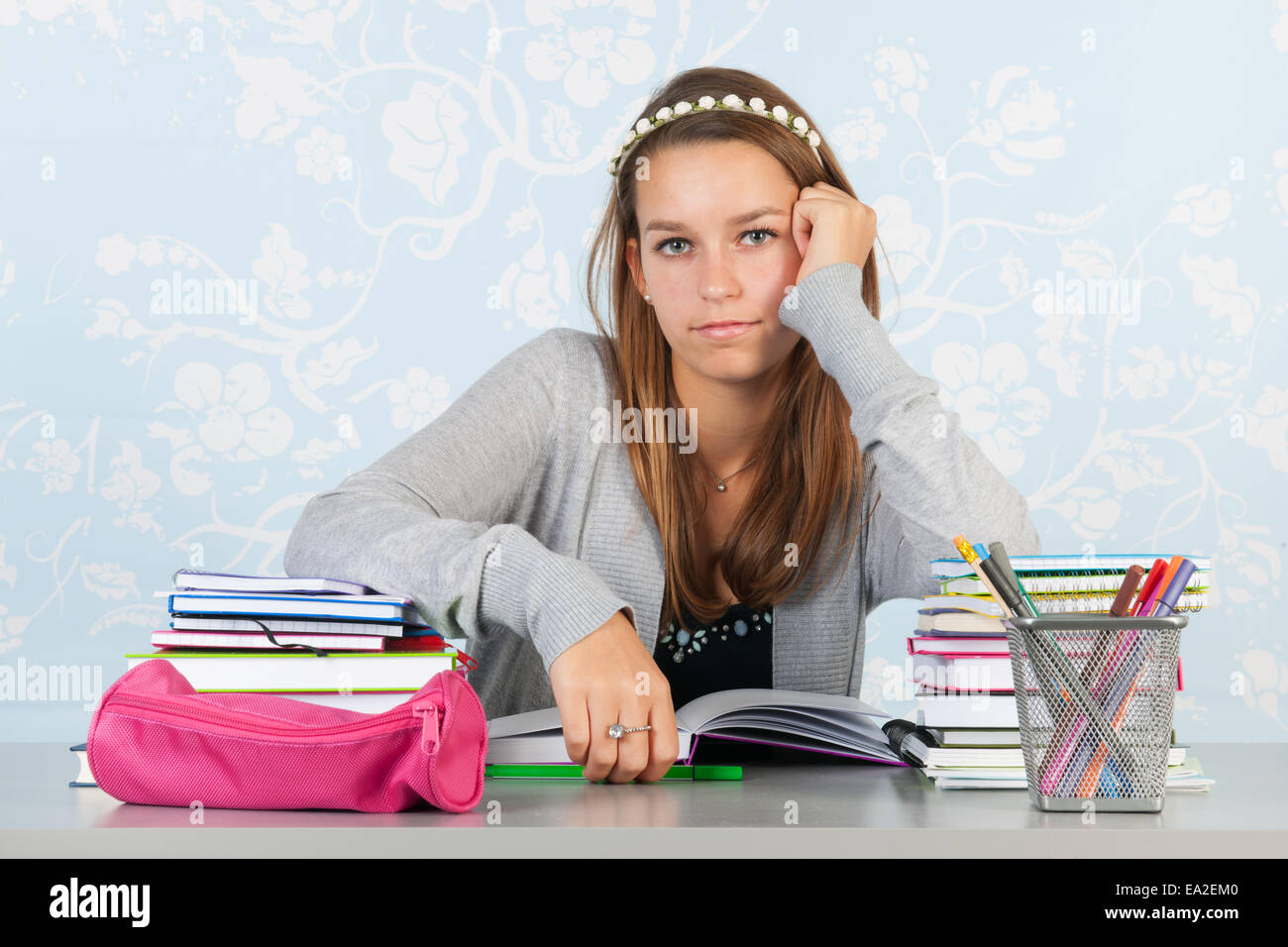 Teen girl sitting at desk with homework for school Stock Photo - Alamy