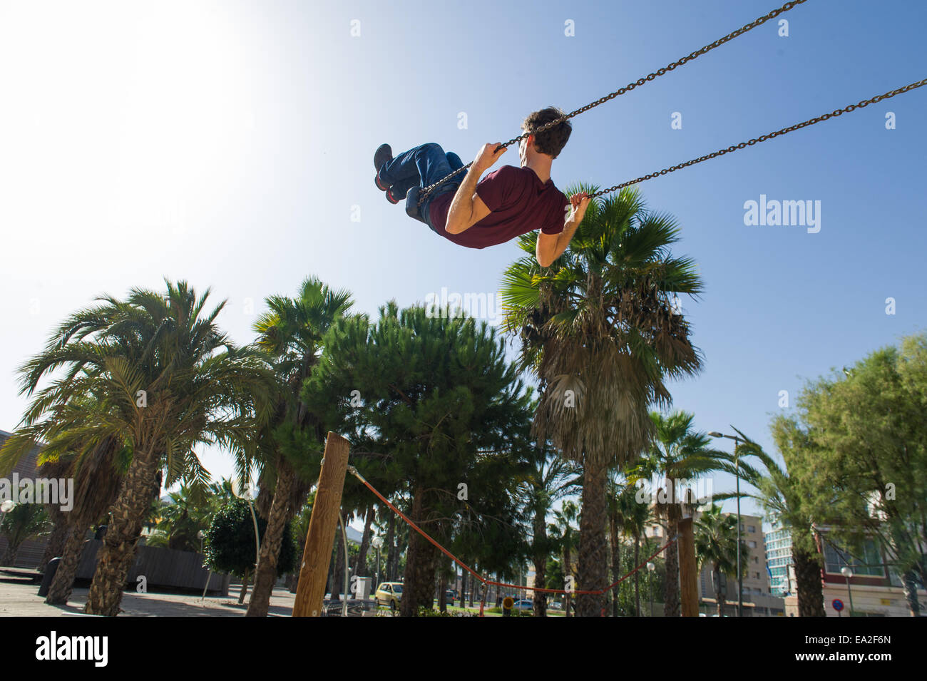 Child swinging on swingset hi-res stock photography and images - Alamy