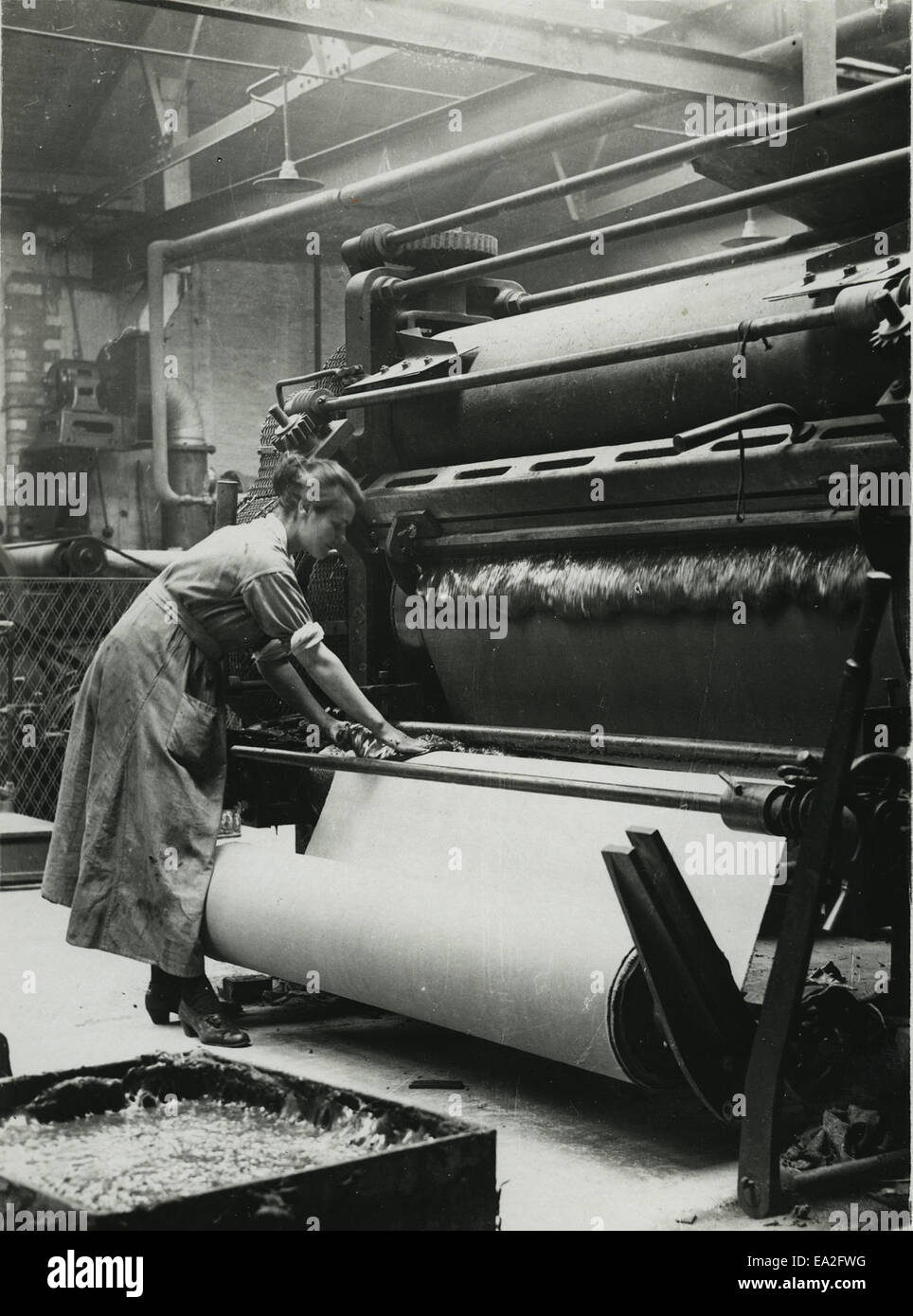 This photograph shows British rubber workers in Lancashire using a ...