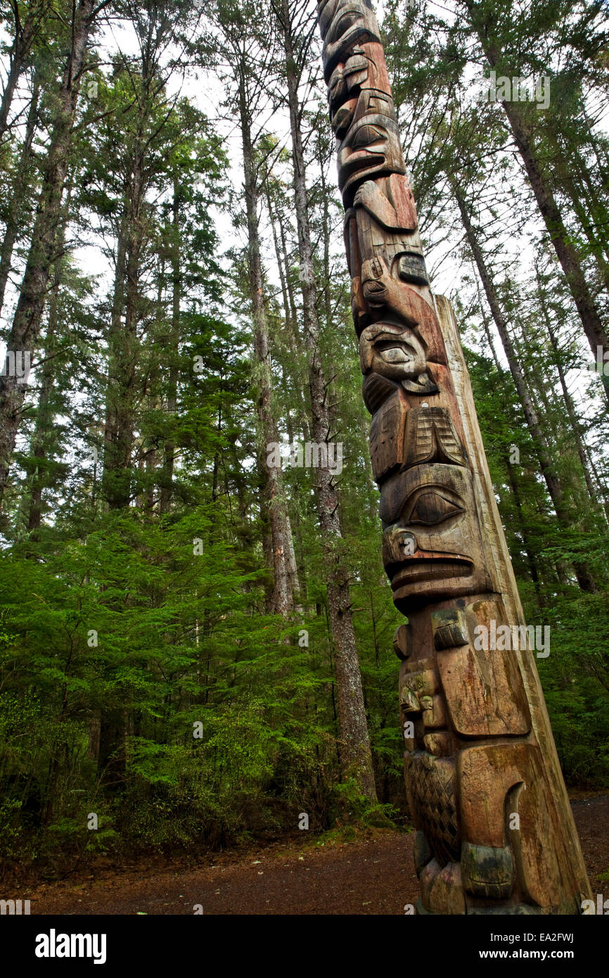 A totem pole along the Totem Trail, surrounded by forest, Sitka ...
