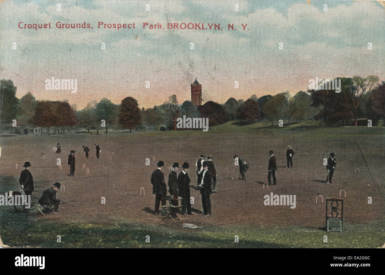 This image features a croquet ground, likely set up in a public park or ...