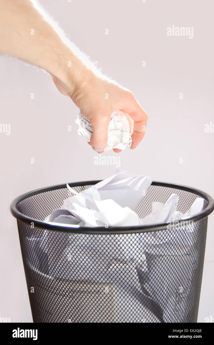 Garbage conceptual image. Man throws paper into a full garbage Stock ...