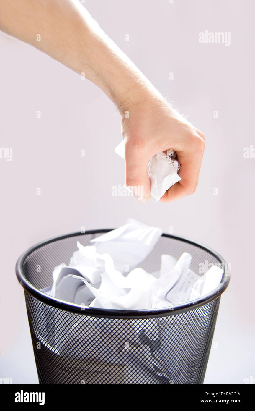 Garbage conceptual image. Man throws paper into a full garbage Stock ...