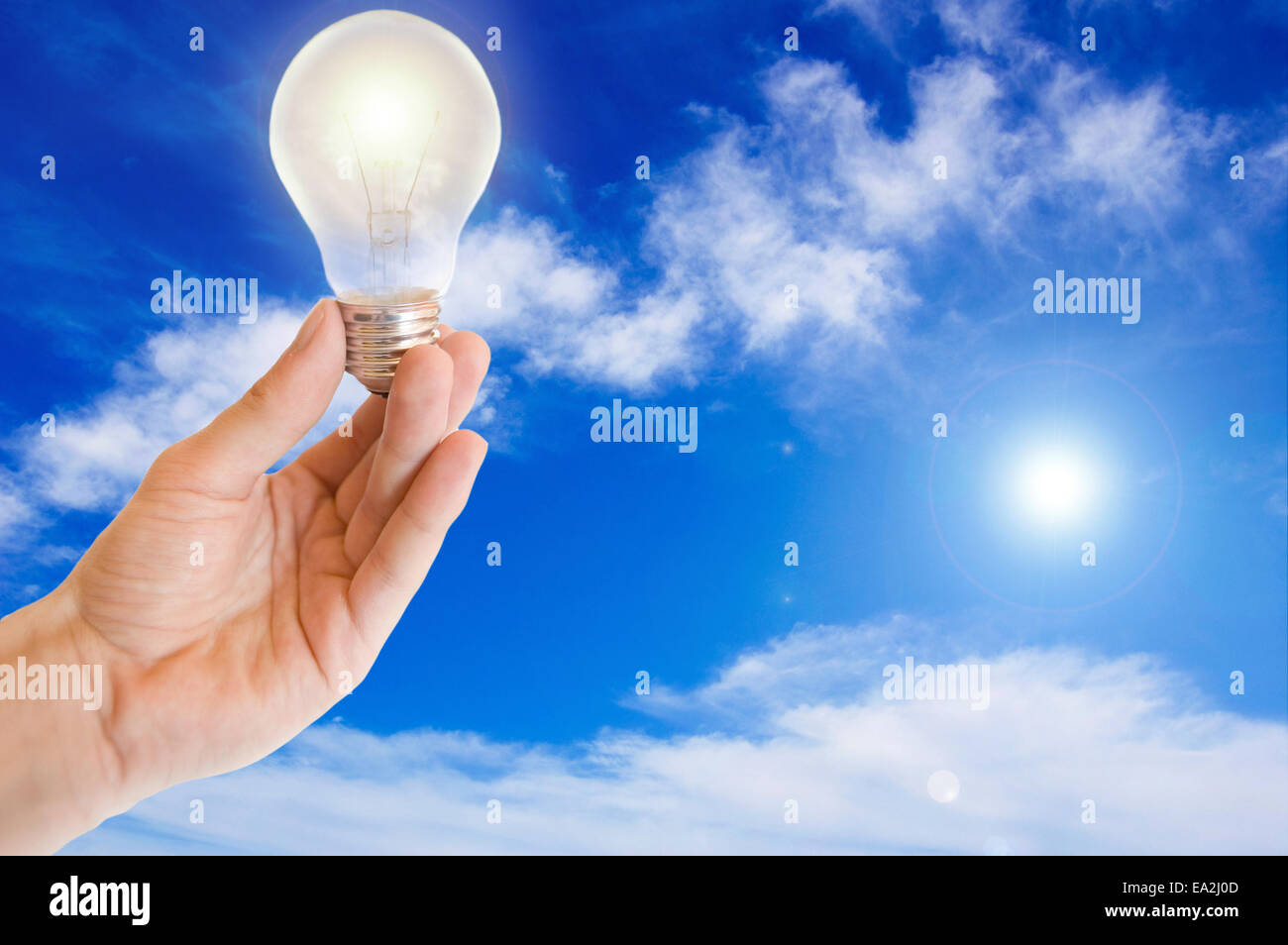 Ecological energy. Hand holds a light bulb against blue sky Stock Photo ...