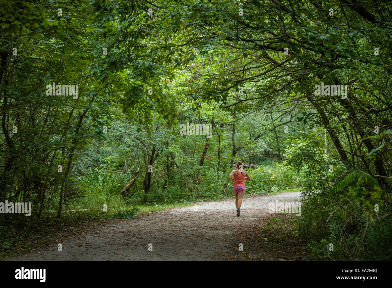 Woman running alone on road hi-res stock photography and images - Alamy