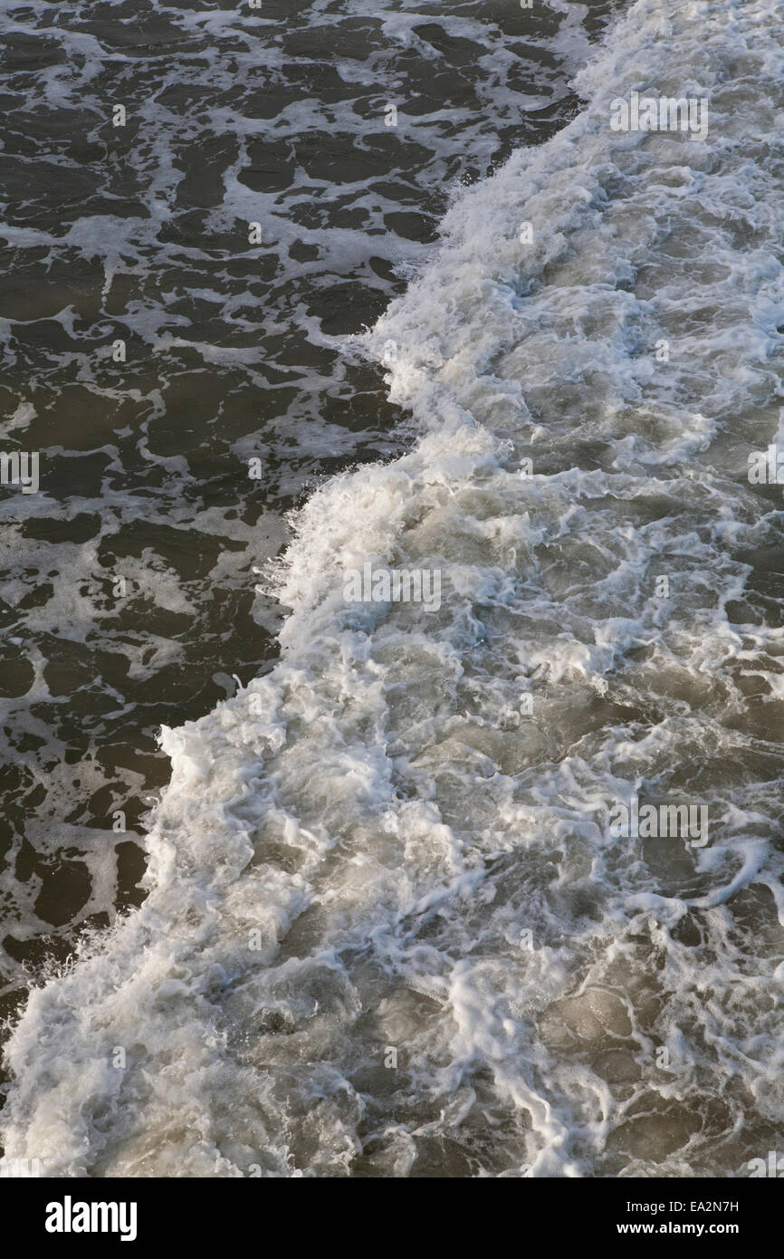 End of a wave flowing on the beach shoreline Stock Photo - Alamy