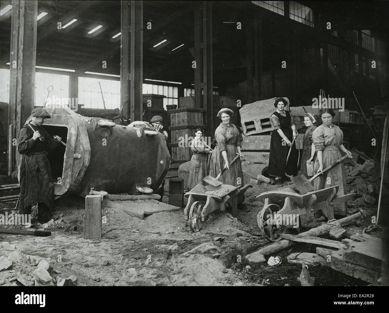 This image captures women engaged in laboring work in a dressing shop ...