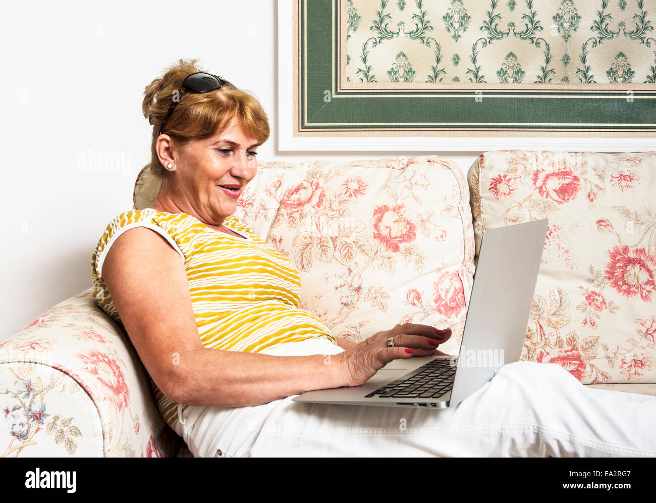 happy adult woman using laptop at home Stock Photo - Alamy