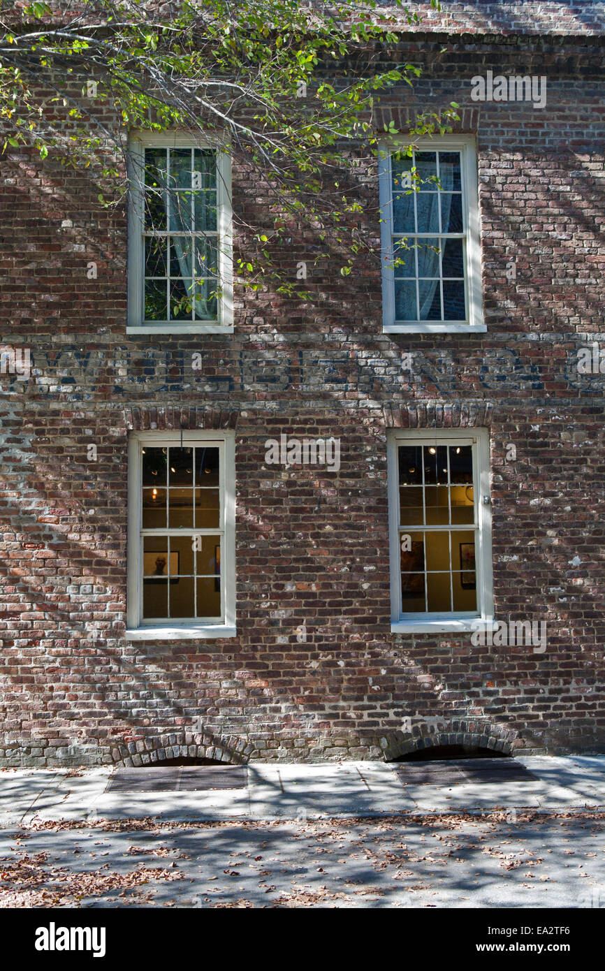 Brickwork building with shadows and windows, historic downtown ...